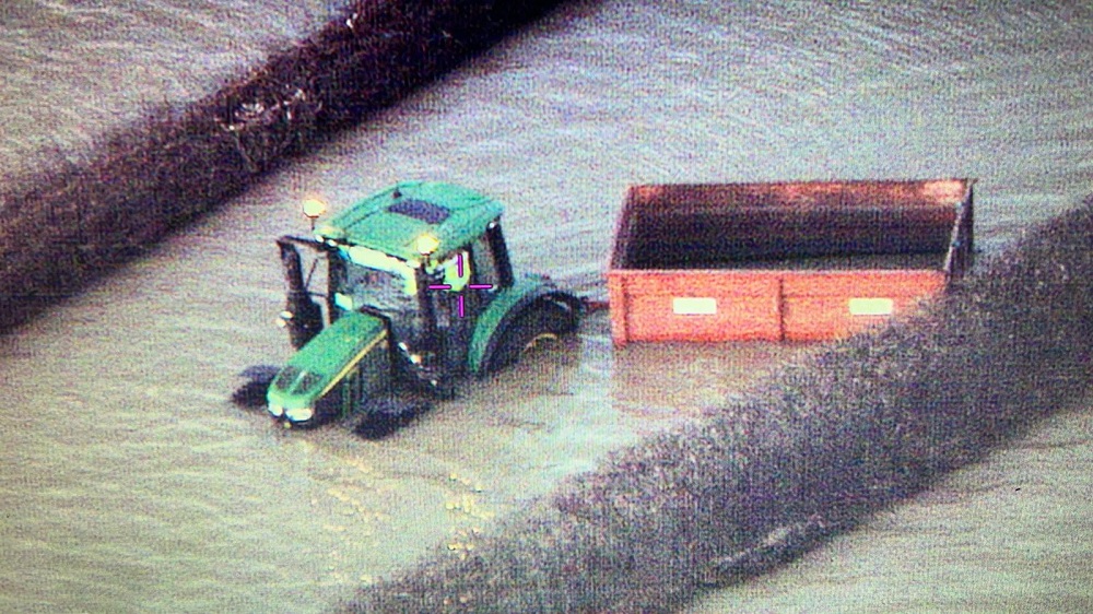 Watch: Man rescued after spending 10 hours trapped in tractor by floodwater
